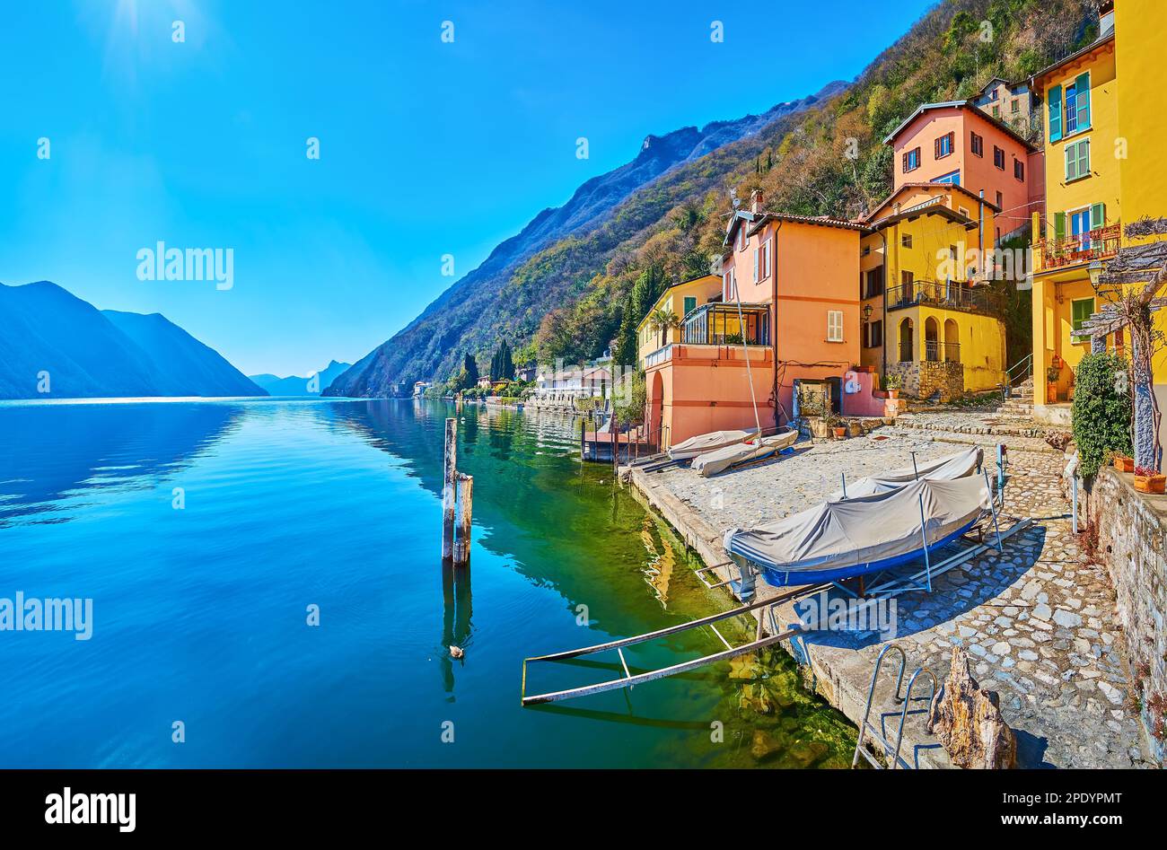 Enjoy Lugano lakeside view with mountain silhouettes and colored houses ...