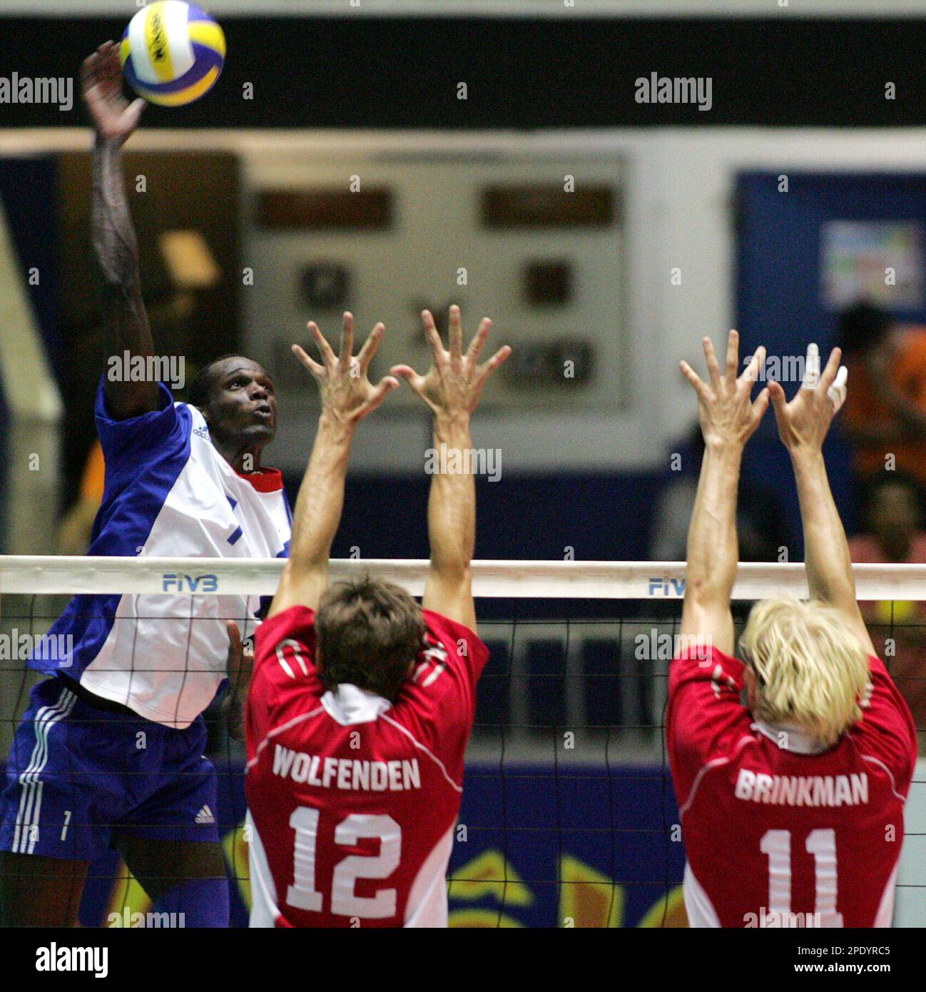 Cuba's Raydel Poey (1) passes the ball against Canada's Chris Wolfenden ...