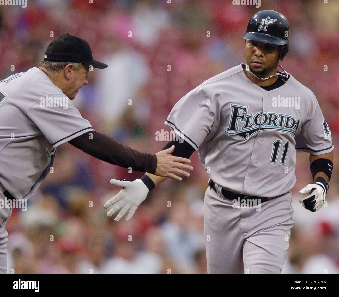 Florida Marlins' Alex Gonzalez (11) is congratulated by third base ...