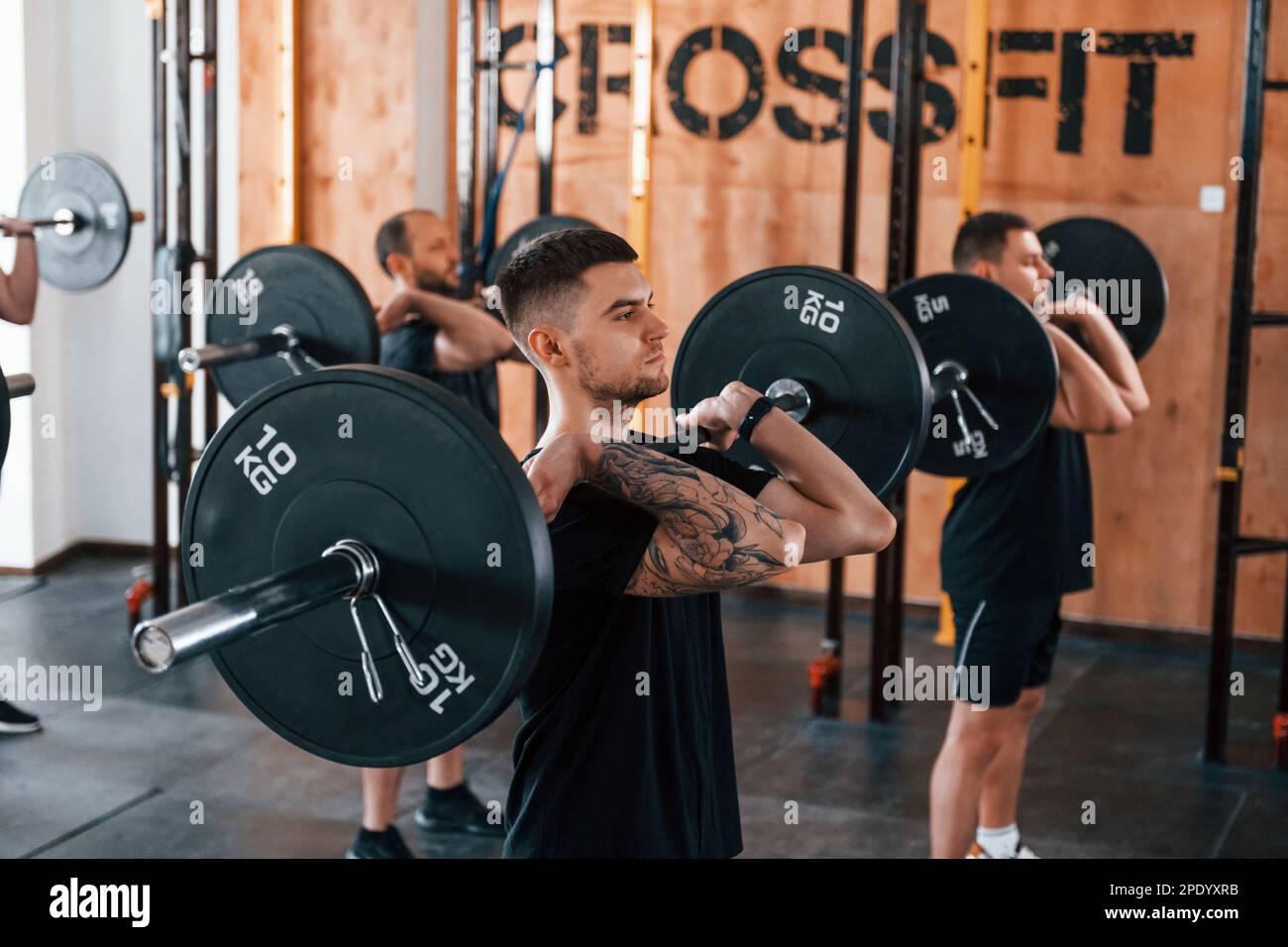 Group of young sportive people have crossfit day indoors in gym Stock ...