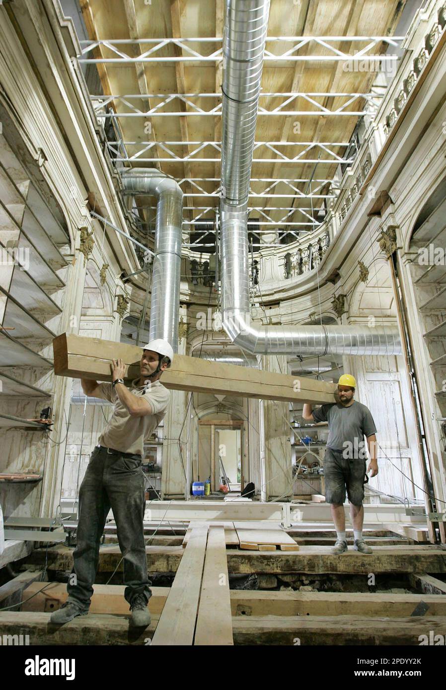 Craftsmen Joachim Gross, and Rene Hoffmann, work to rebuild the burned ...