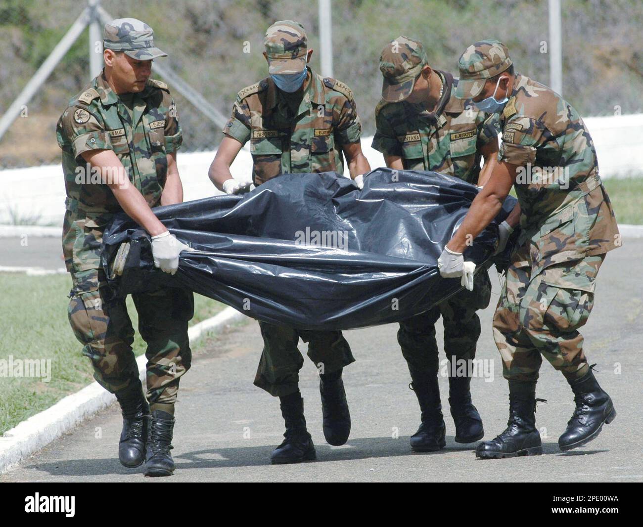 Army soldiers carry the body of one of eight right-wing paramilitary ...