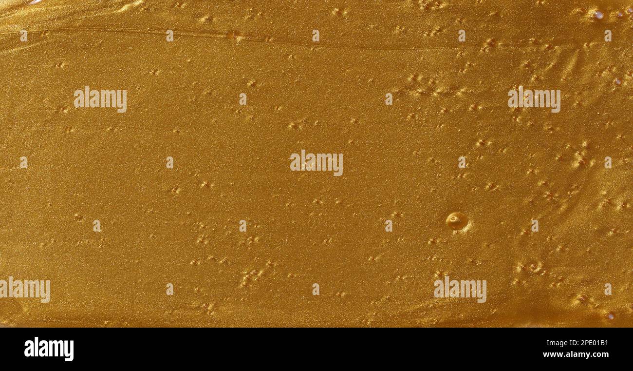 Sample of golden glitter gel with small particles, texture of ...