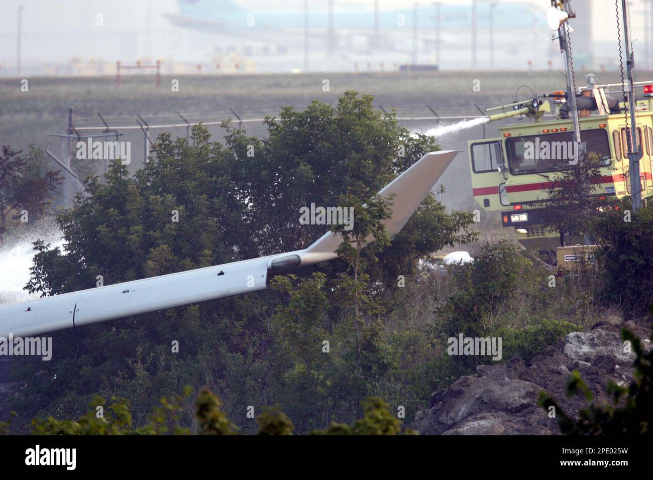 Firefighters hose down the fuselage of an Air France Airbus A340 jet ...