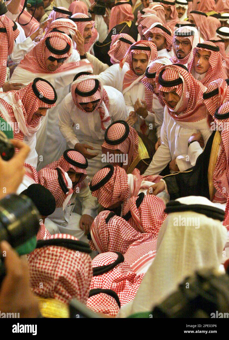 Relaltives of the late Kng Fahd prepare to carry his coffin following ...