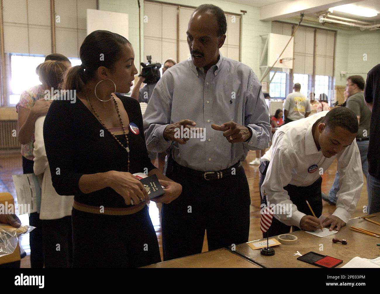 Detroit mayoral candidate Freman Hendrix, center, reminds his daughter, Erin, left, to fill out ...