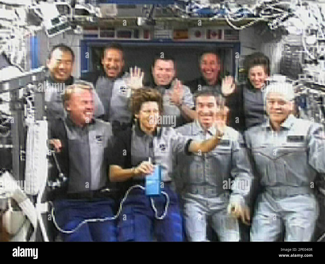 The space shuttle Discovery and international space station crews wave ...