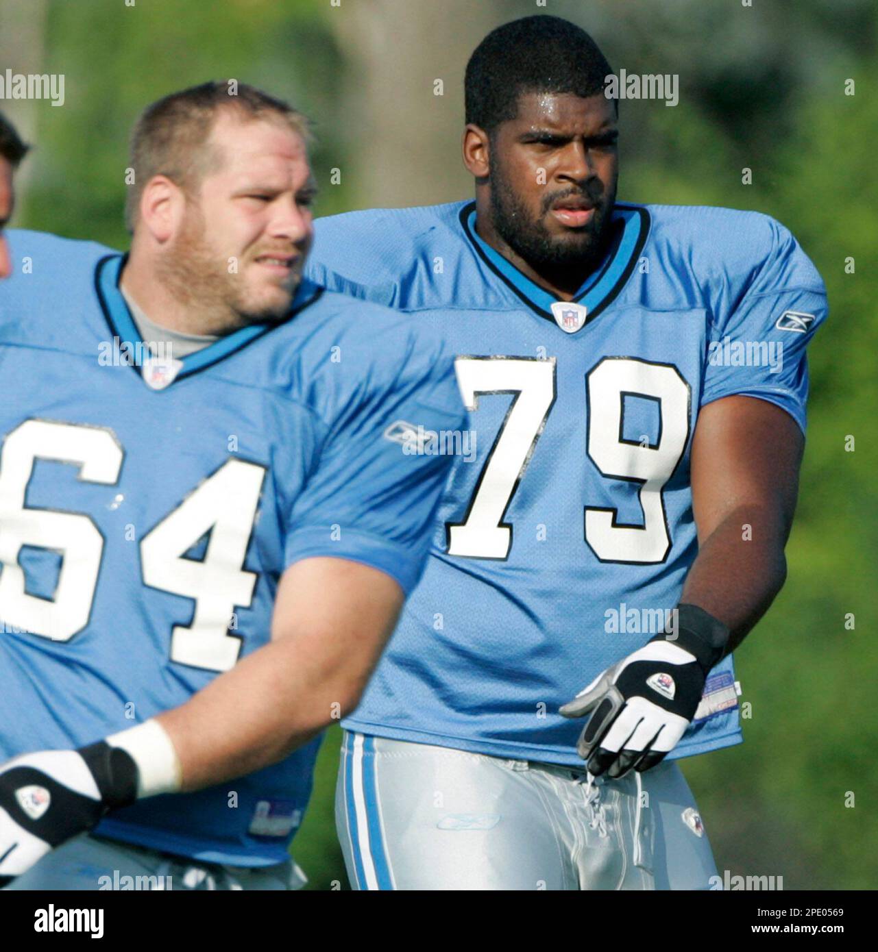 Detroit Lions tackle Kelly Butler (79) and Rick DeMulling (64) loosen ...