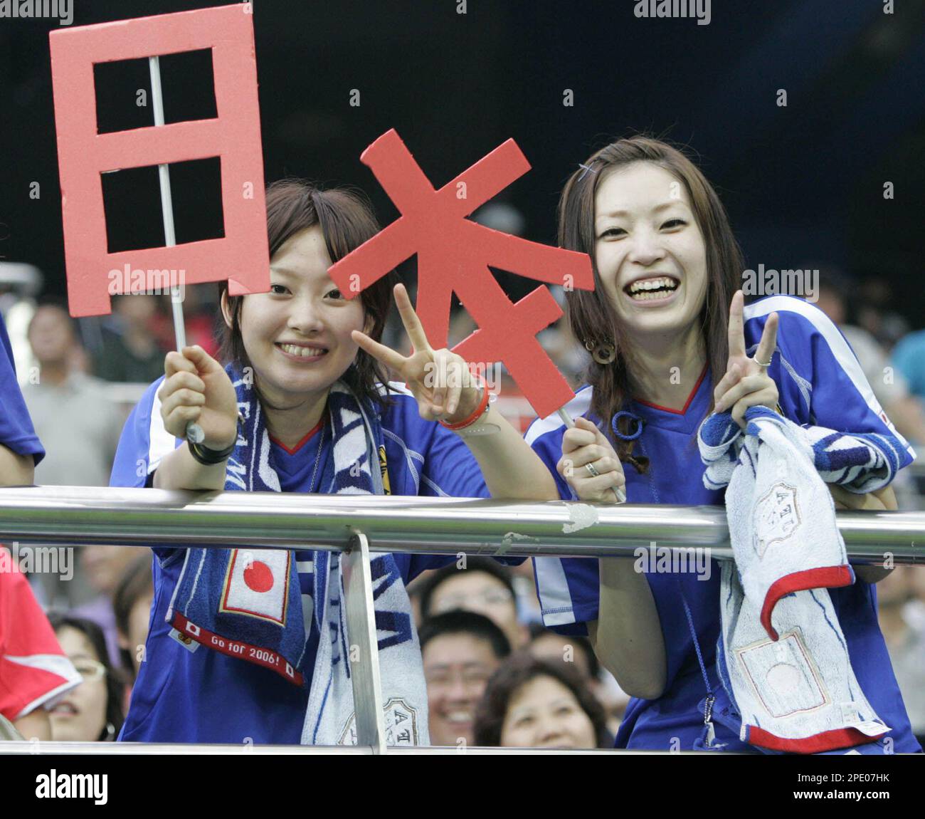 Japanese women cheer their team before the match against North Korea ...