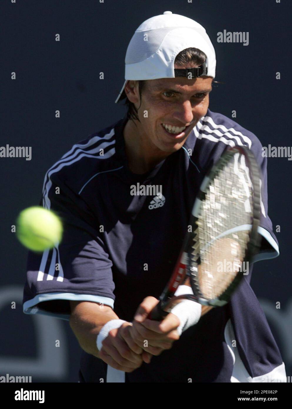 Juan Ignacio Chela returns against Andre Agassi during their semifinal ...