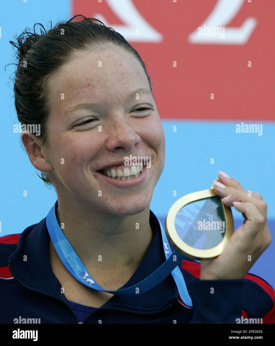 Women's 800-meter gold medalist Kate Ziegler shows off her medal during ...