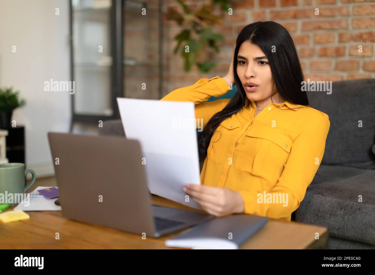 Woman holding papers shocked hi-res stock photography and images - Alamy