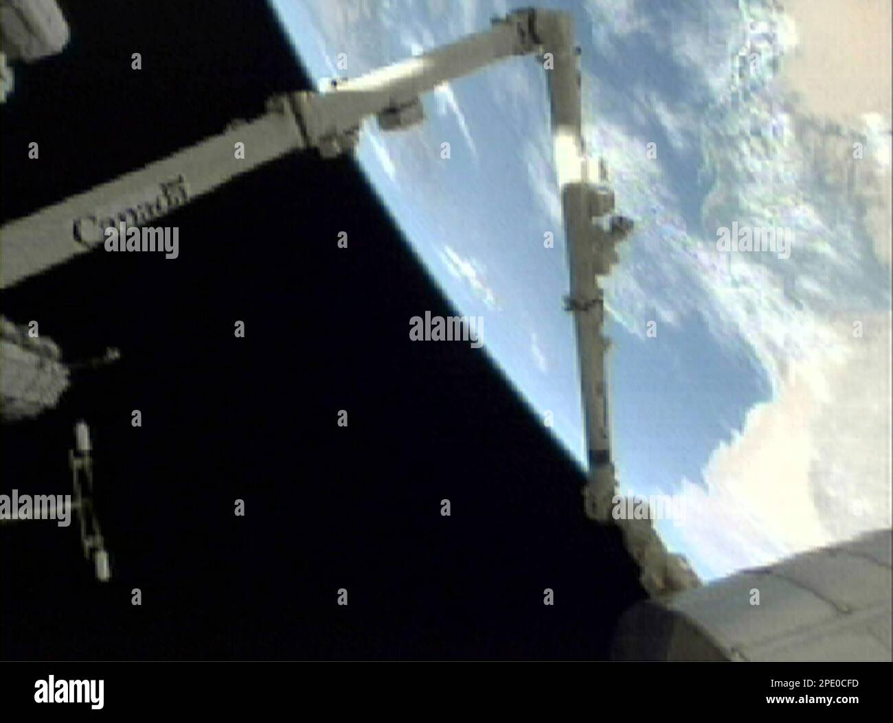 Discovery's robot arm grapples the Raffaello Multi-Purpose Logistics ...