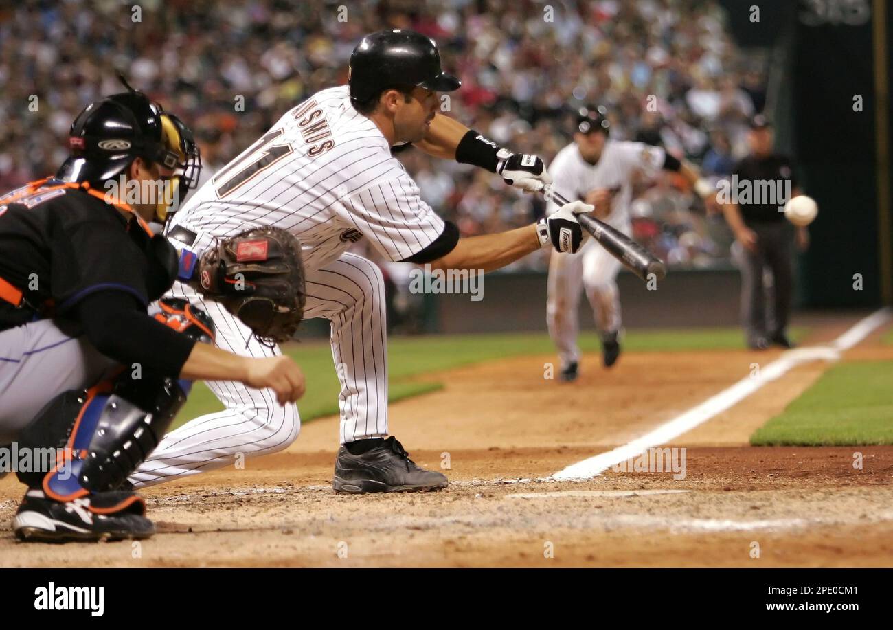 Houston Astros' Brad Ausmus (11) reaches to bunt the ball on a suicide ...