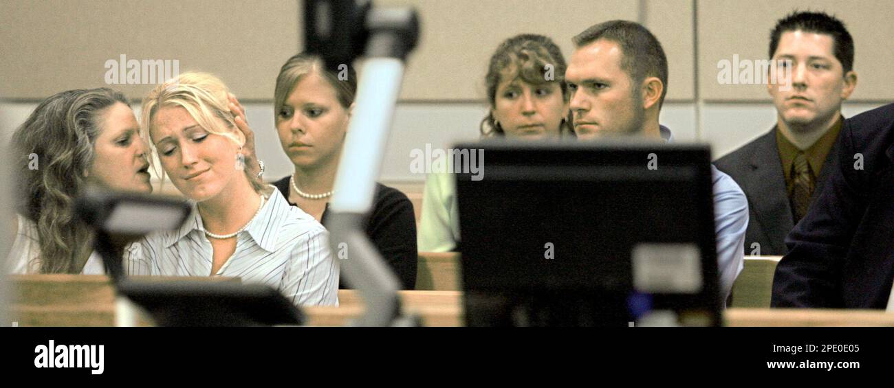 A weeping Jessica Coleman, 22, second from left, is comforted Wednesday ...