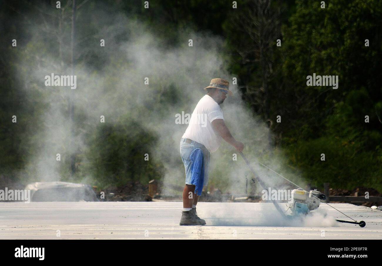 Fred Ferrara is shrouded in a cloud of dust as he uses a quick cut ...