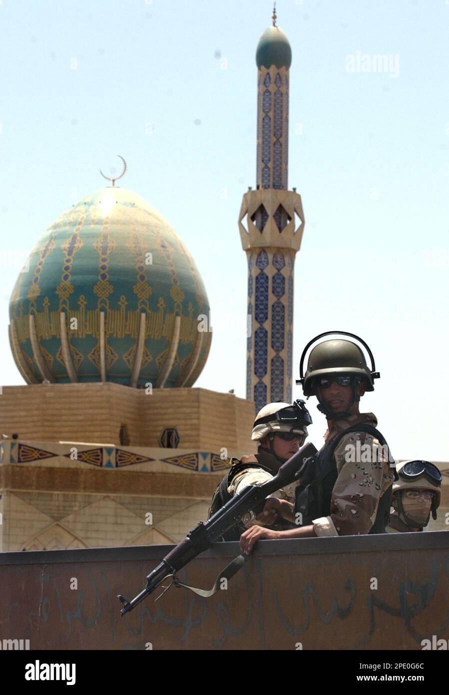 Iraqi soldiers walk a foot patrol in front of the Ibn Bunniyah mosque ...