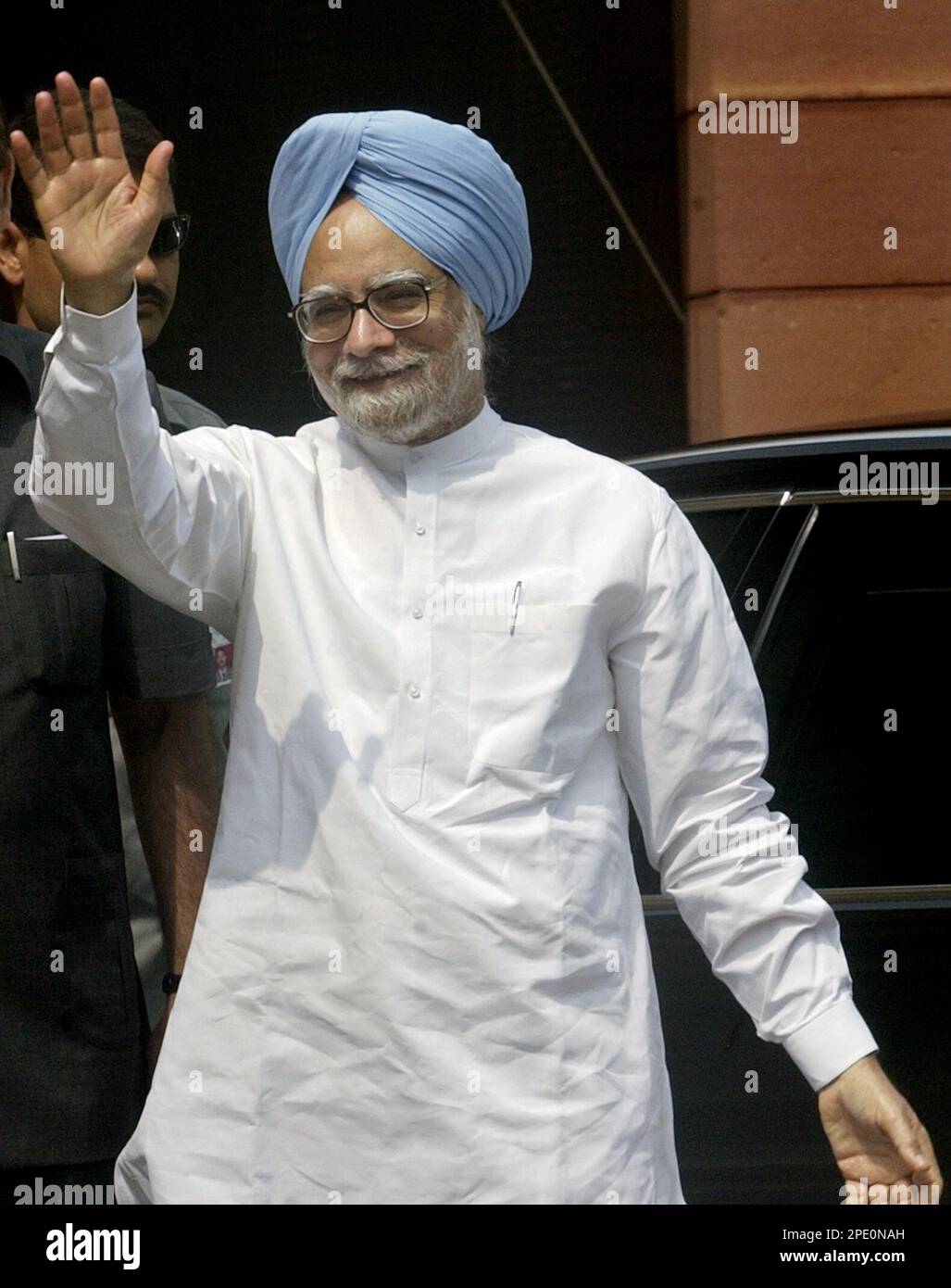 Indian Prime Minister Manmohan Singh waves as he arrives for the monsoon session of the Indian ...