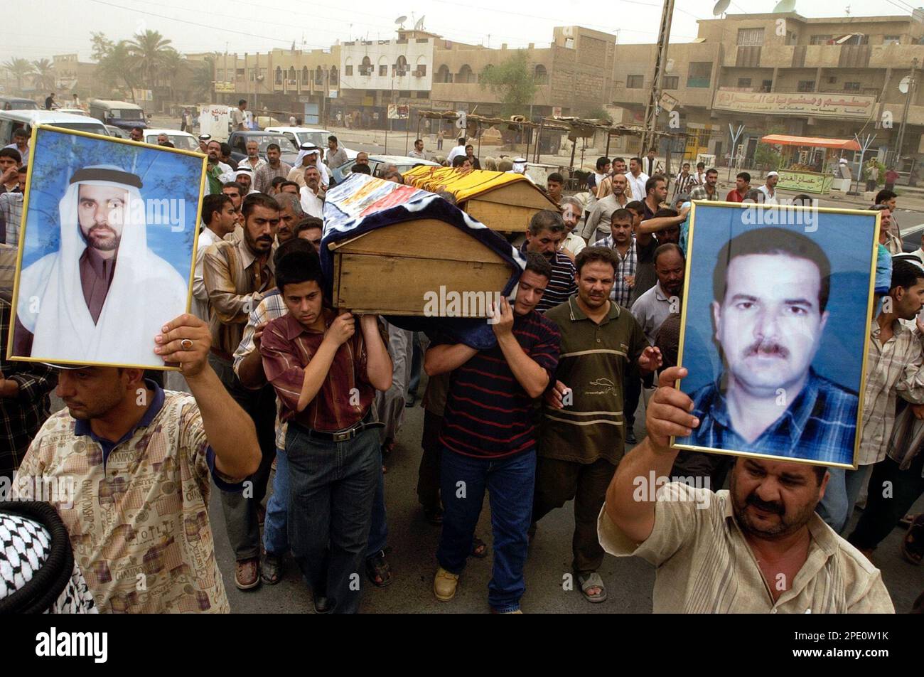 Friends and family members carry the coffins of imam Alaa Salih al ...