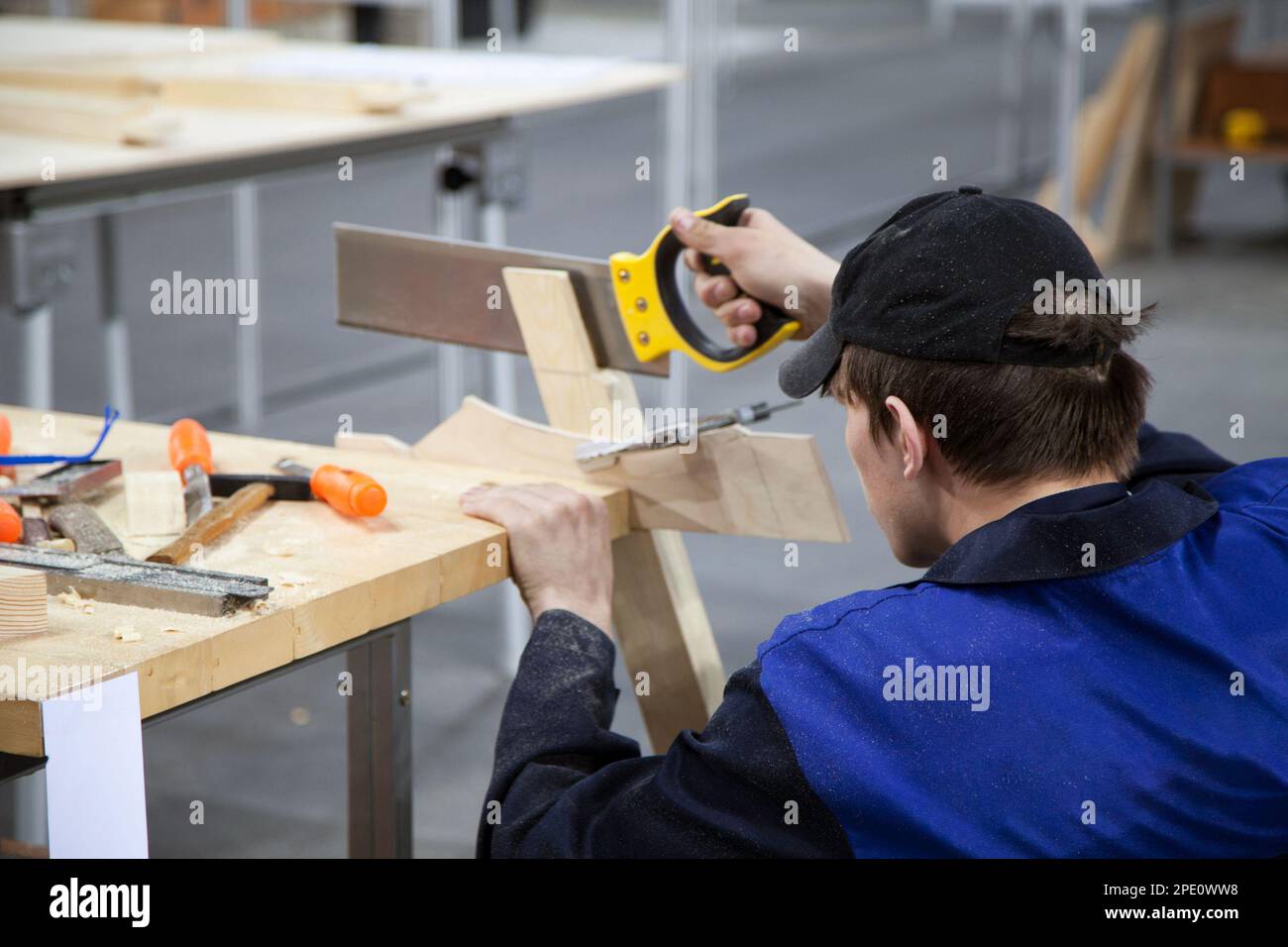 Khabarovsk, Russia - April 24, 2016:Carpenter in a blue uniform working ...