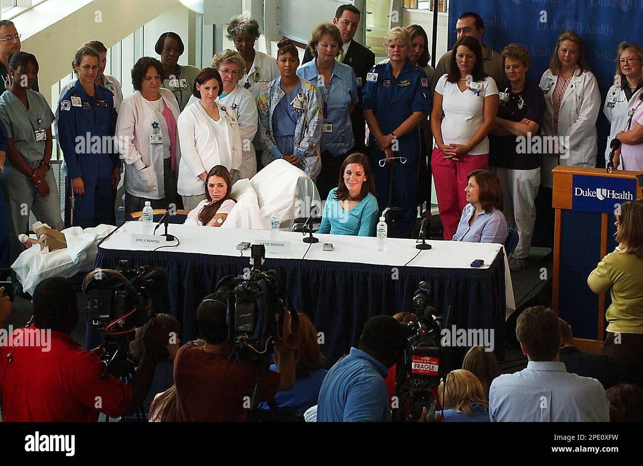 Emily Benton, 20, left, and her sister Katie Benton, 21, are flanked by ...