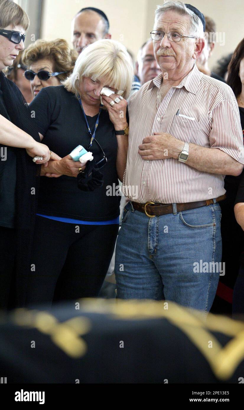 Arieh and Naomi Rosenberg, center, the parents of a Anat Rosenberg, who ...