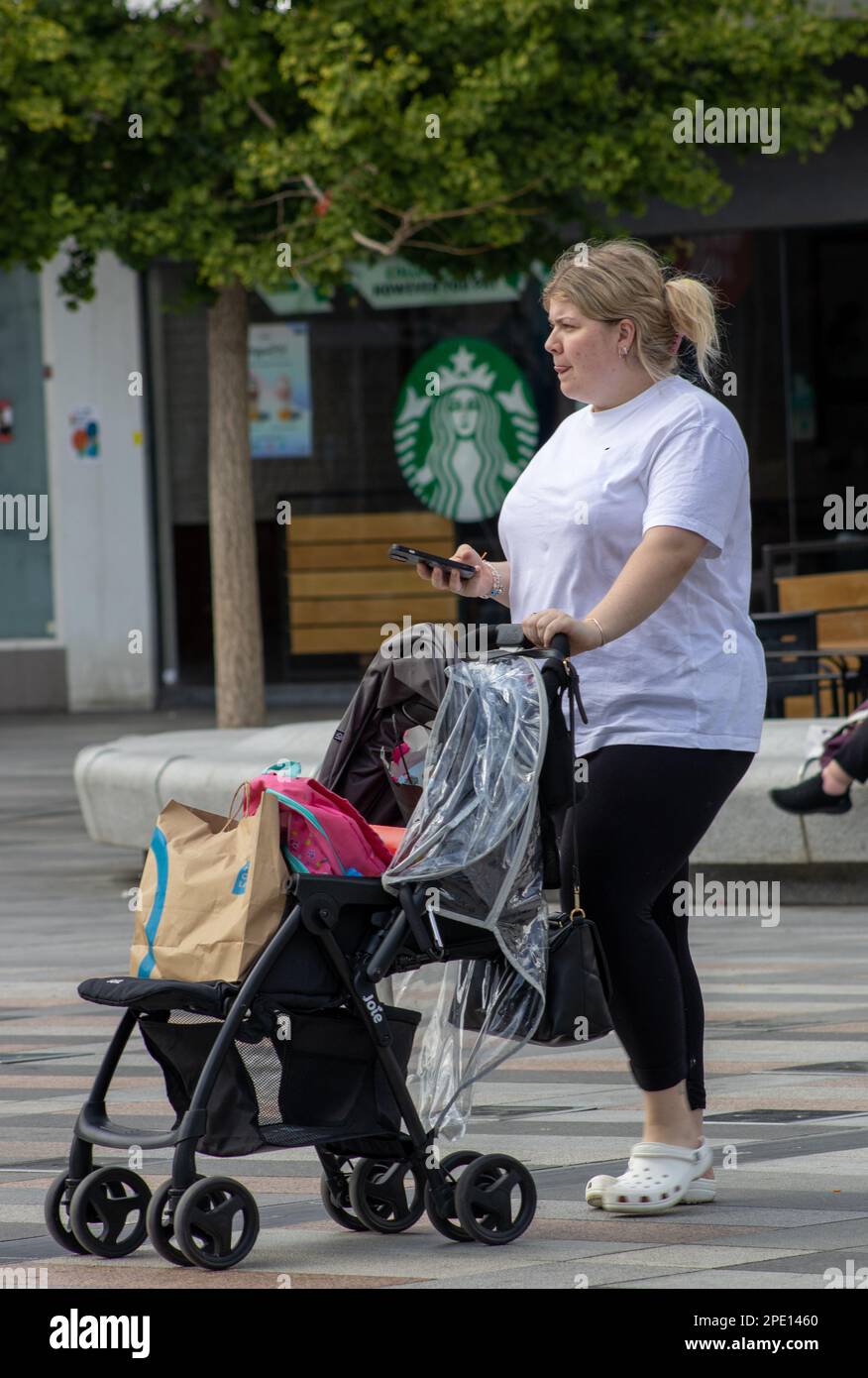Mum pushing a buggy Stock Photo - Alamy