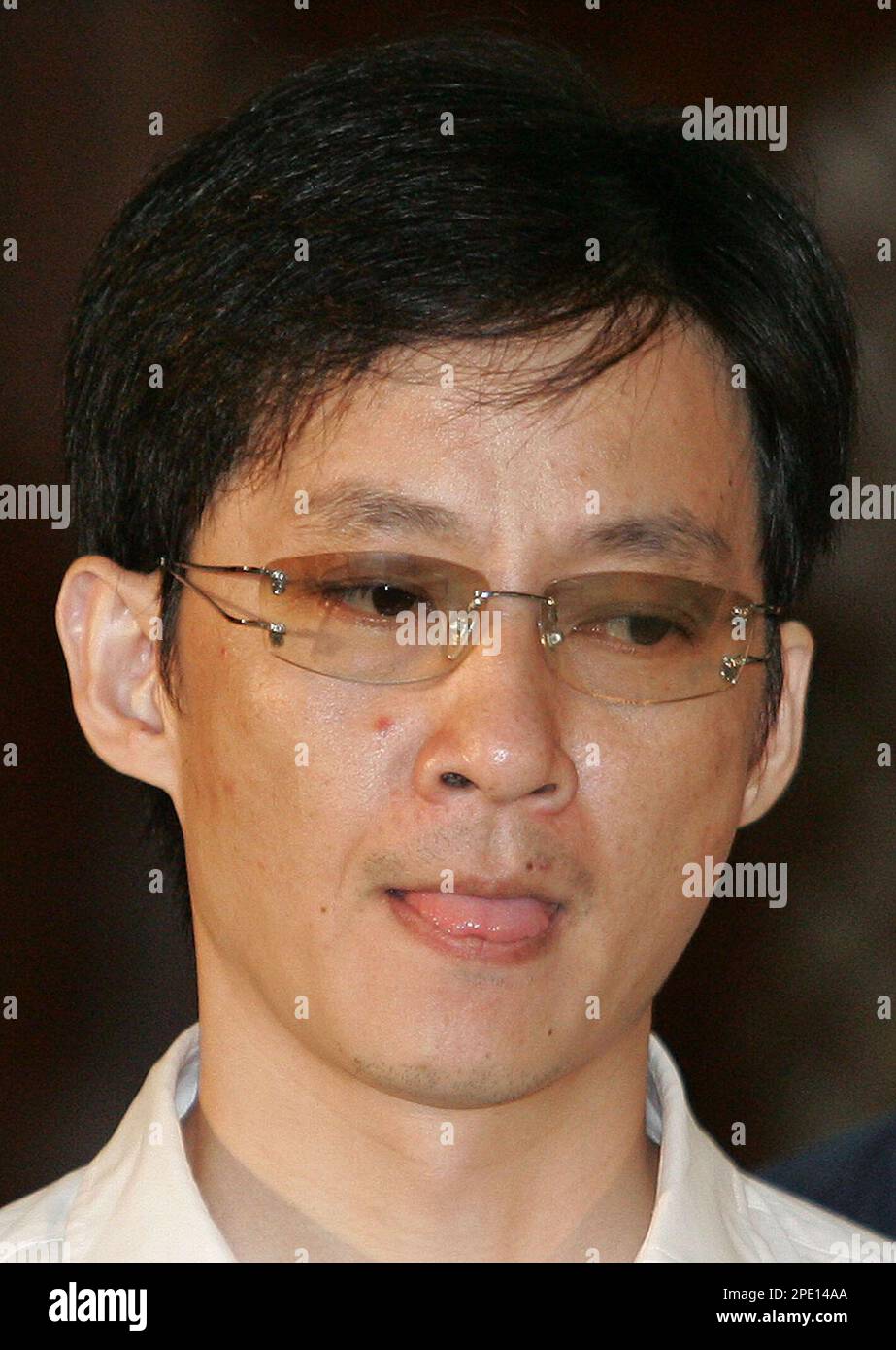 Suspected Chinese-Filipino drug lord, Calvin Tan, plays with his tongue ...