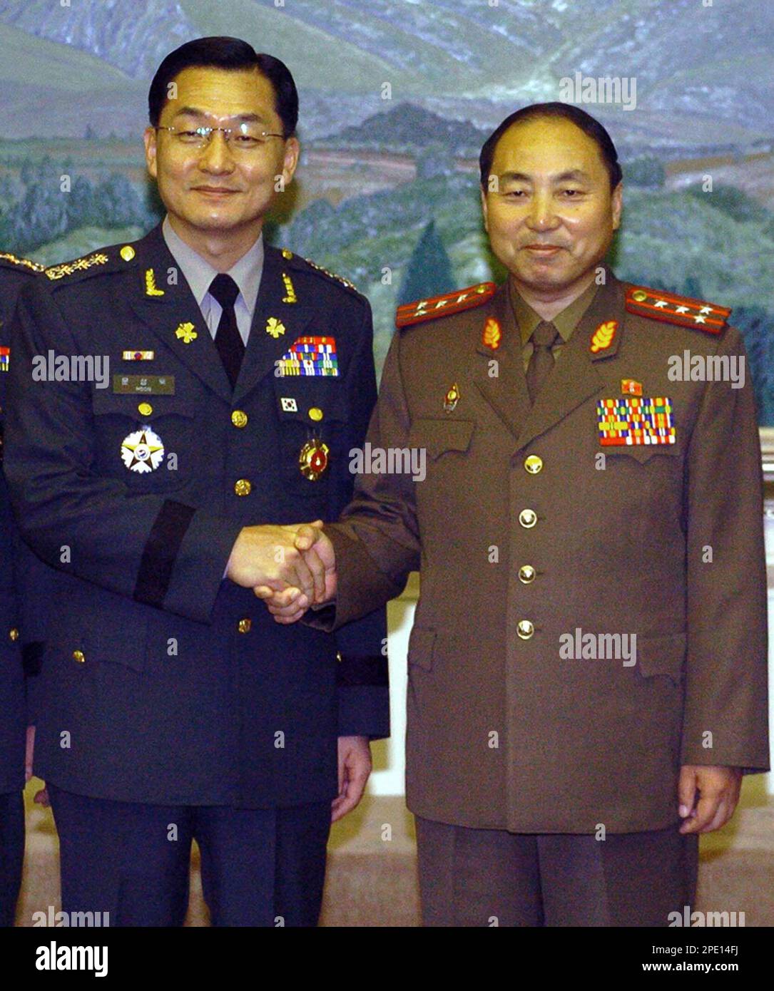 South Korea's chief delegate, Moon Sung-Muk, left, shakes hands with ...