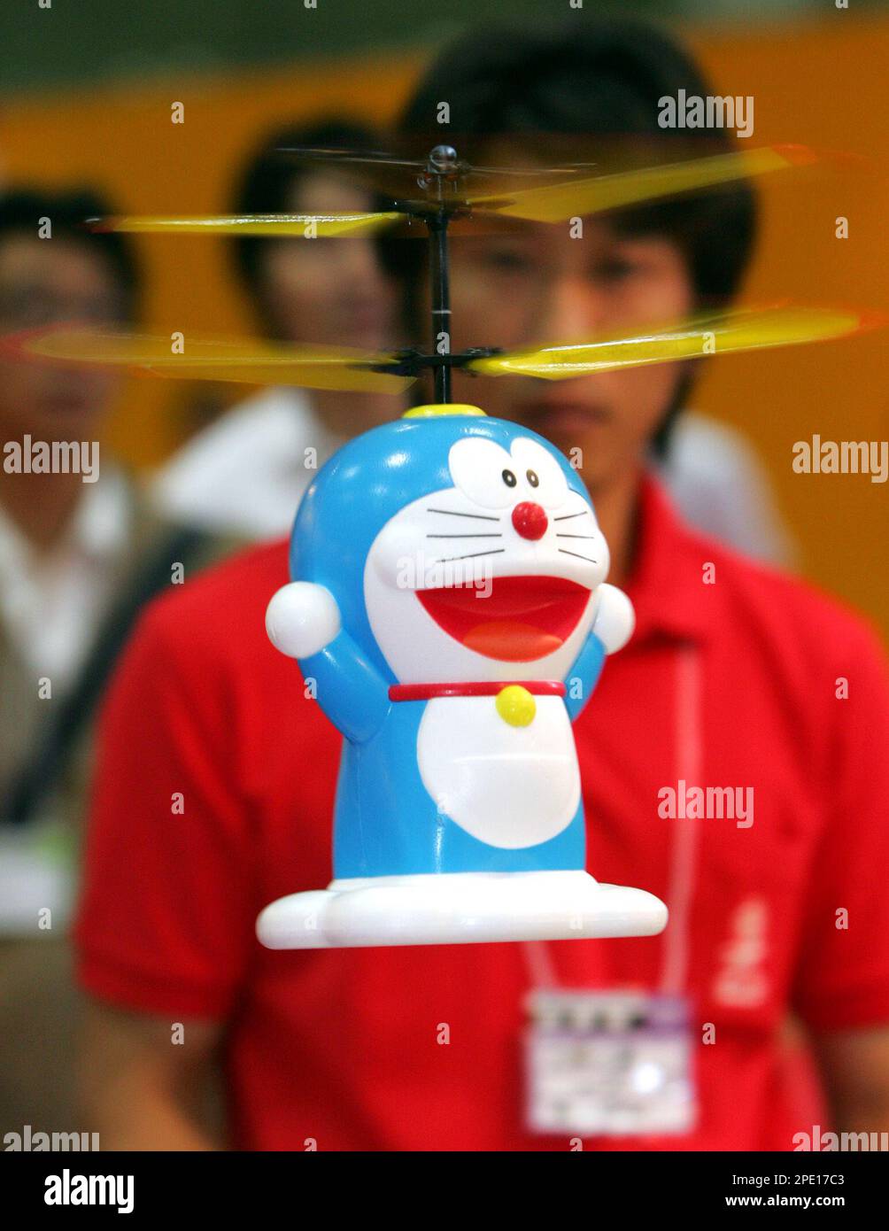Japanese popular cartoon character cat-robot "Doraemon" flies in front ...