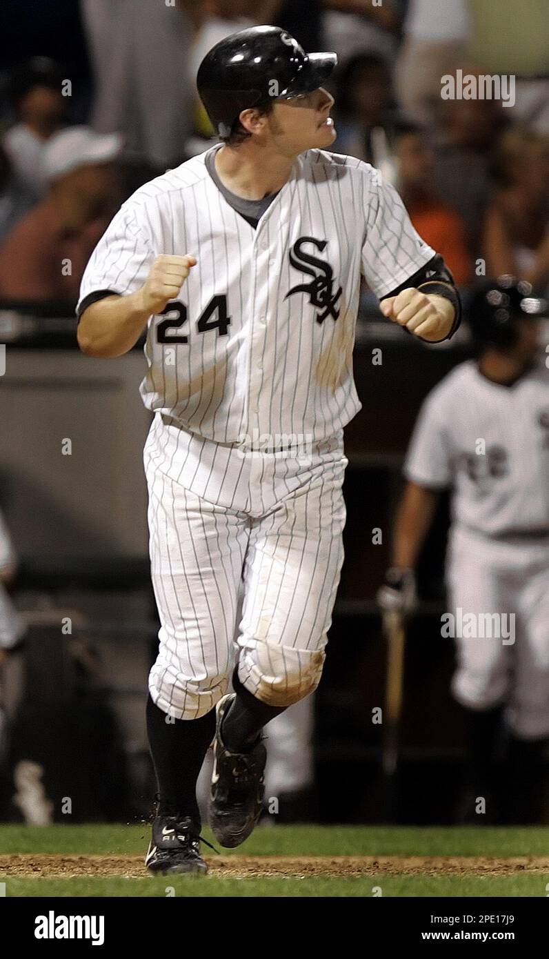 Chicago White Sox's Joe Crede pumps his fist as he watches his three ...