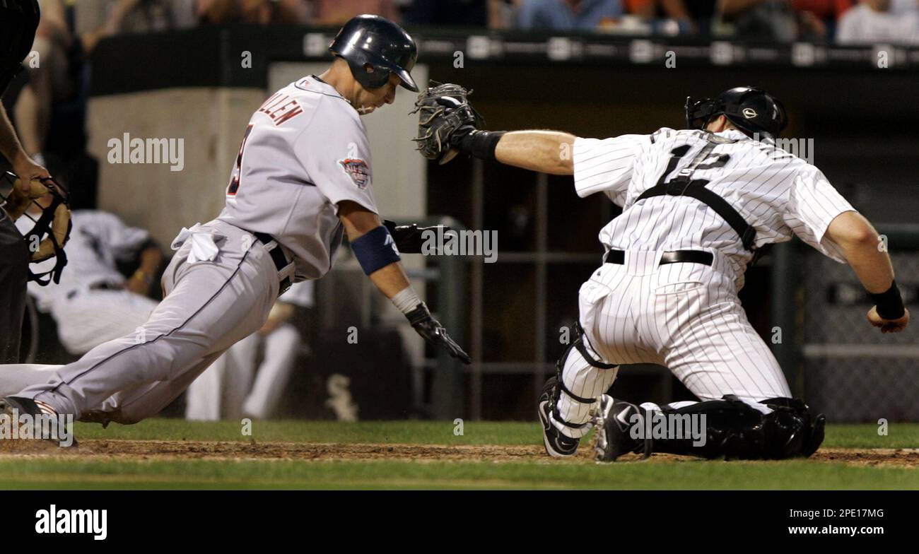 Detroit Tigers' Carlos Guillen, left, is tagged out at home by Chicago ...