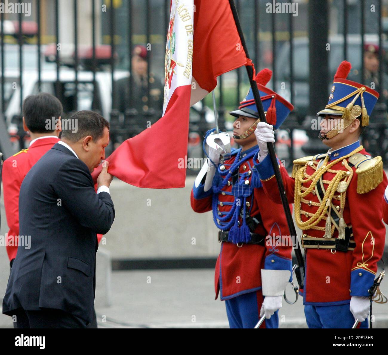 Venezuelan President Hugo Chavez kisses the Peruvian flag upon his ...