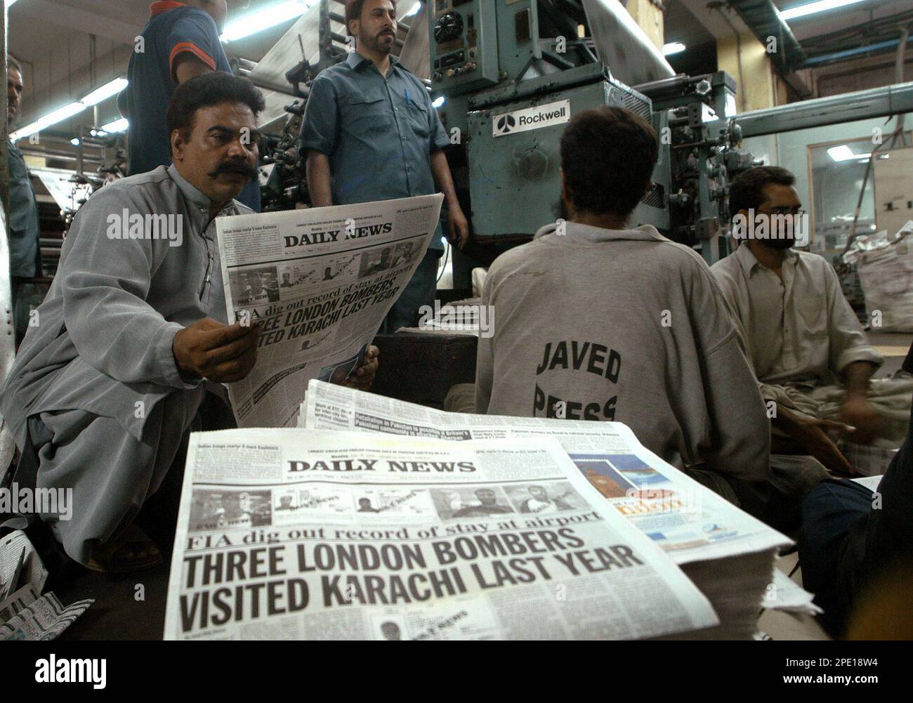 Pakistani employees of the Daily News, sort out copies of the newspaper ...