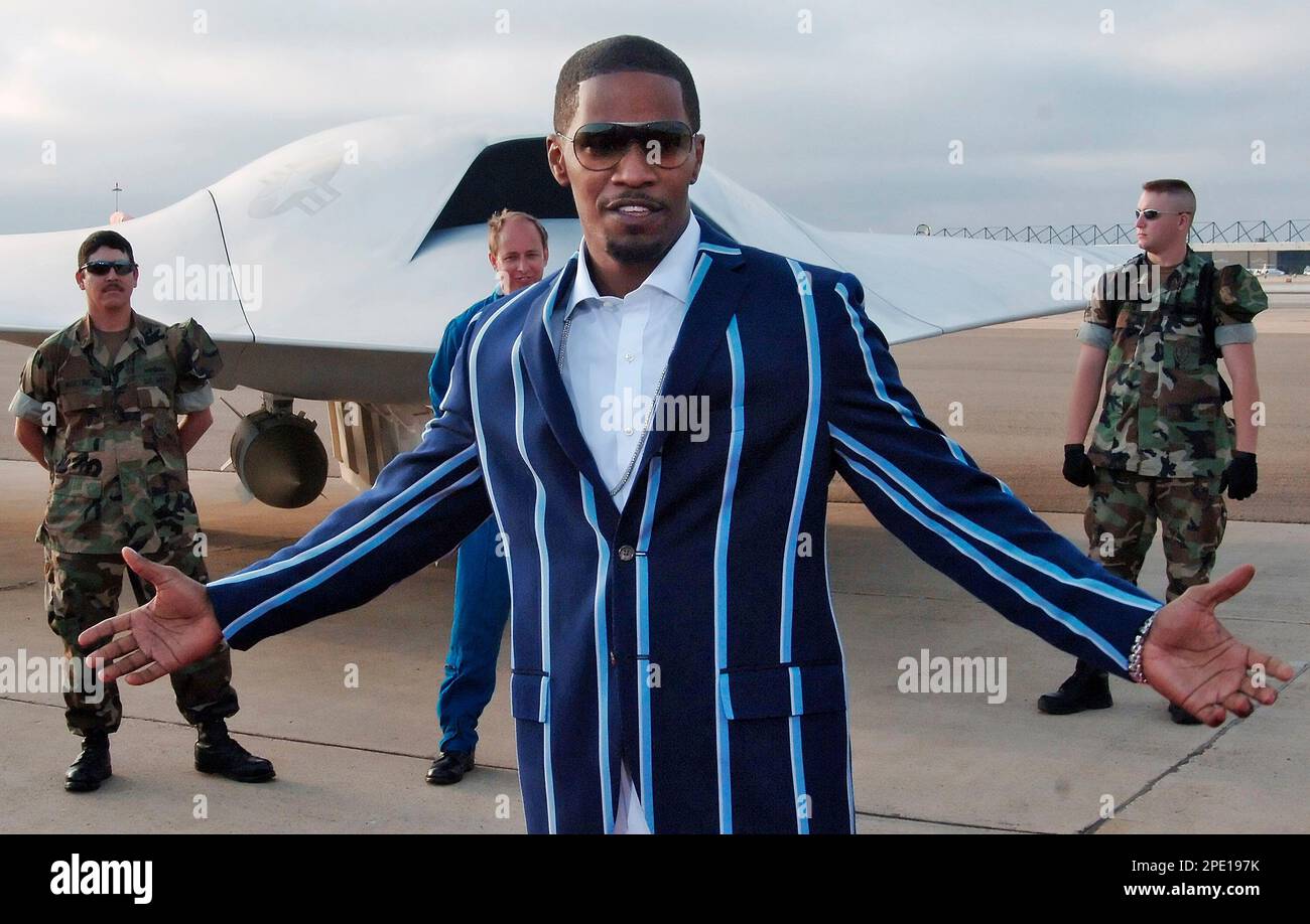 Actor Jamie Foxx poses in front of a model of an unmanned aircraft as ...