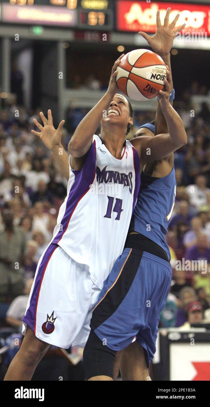 Sacramento Monarchs forward Nicole Powell, left, goes up for the shot ...