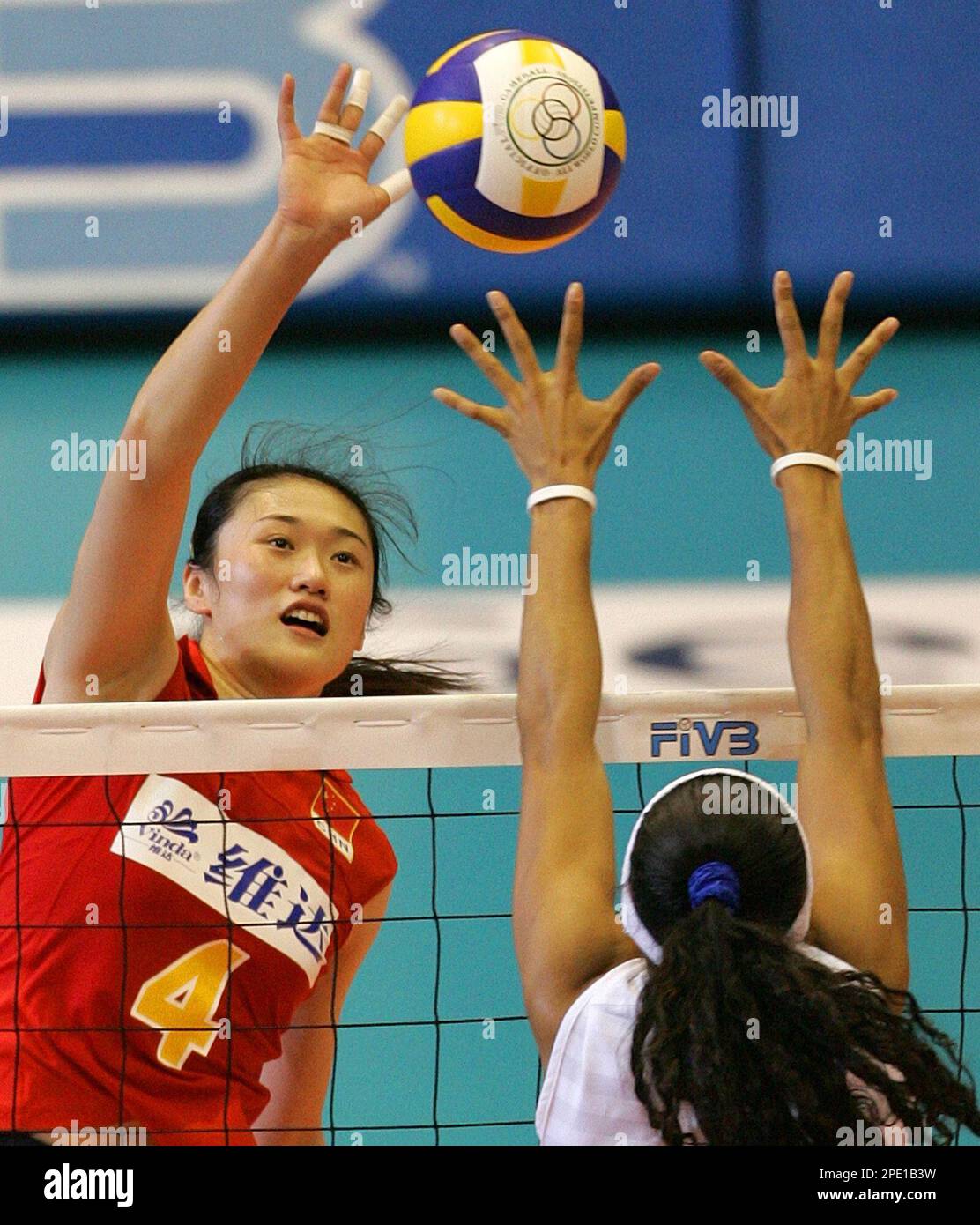 China's Liu Yanan, left, spikes the ball against Brazil's Paula Pequeno ...