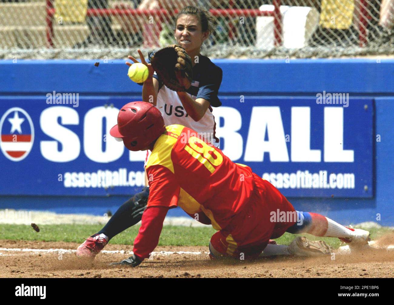 China's Li Chunxia slides safely into third base as USA's Vicky Galindo ...