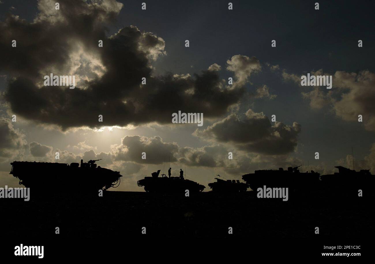 Israeli army tanks line up at an army staging area near Kibbutz ...