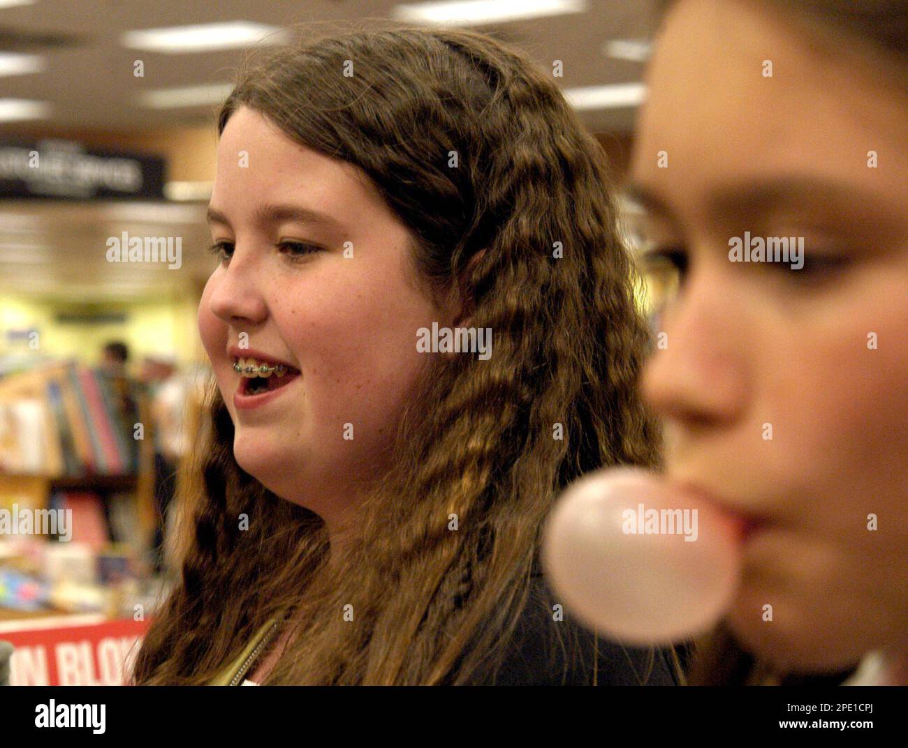 Miana Breed, 12, left, stands in line with her friend, Amanda Keyser ...
