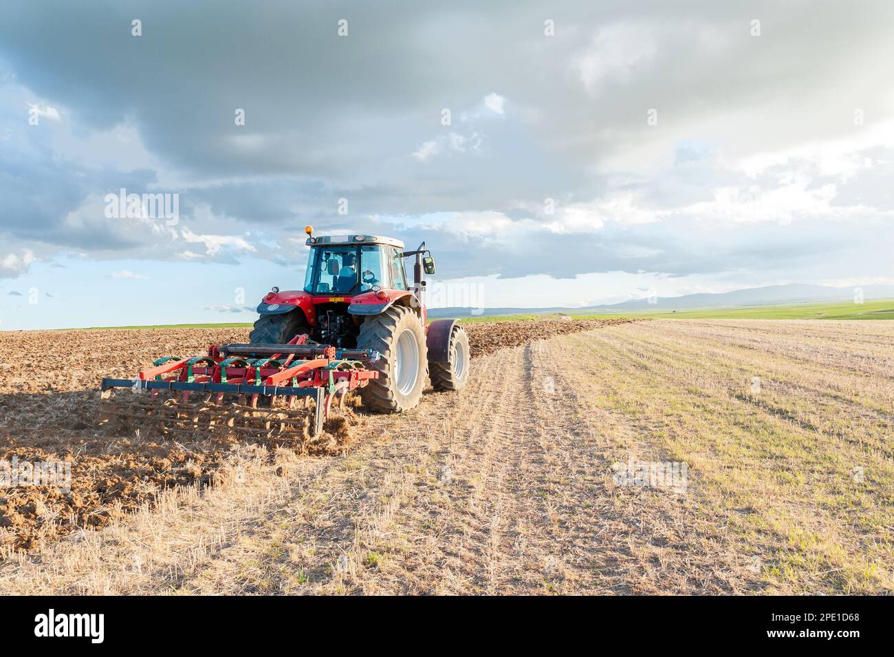 farmer with tractor ploughing the land at sunset Stock Photo - Alamy