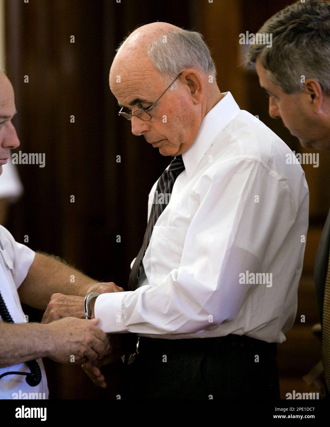 A court officer handcuffs the Rev. Donald Bowen, center, as Bowen's ...