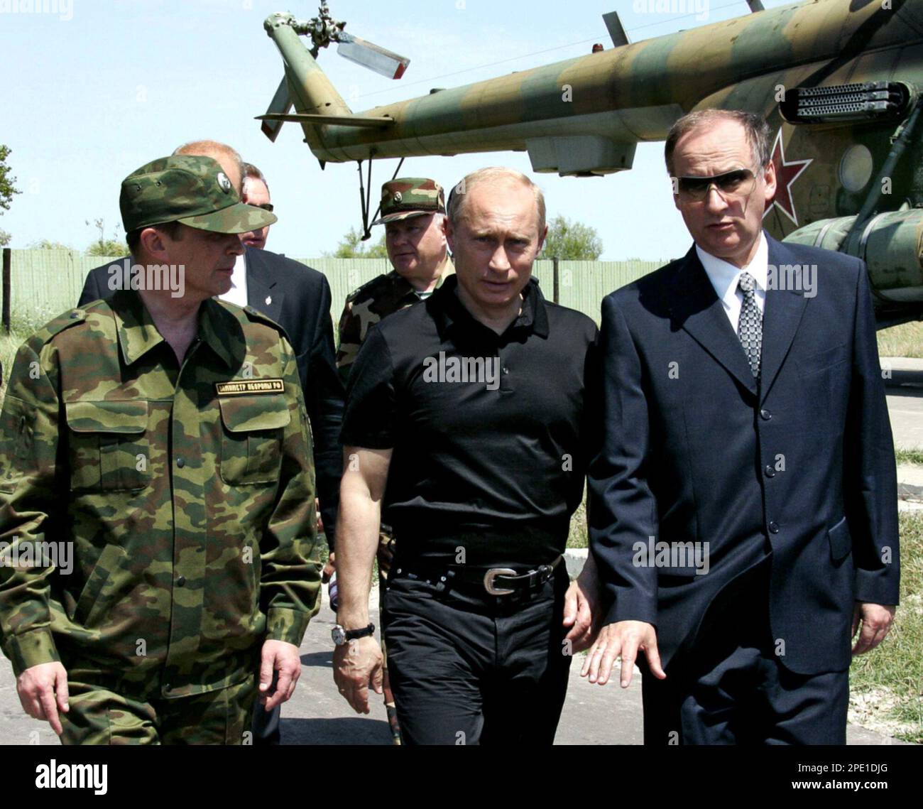 President Vladimir Putin, flanked by Defense Minister Sergei Ivanov ...