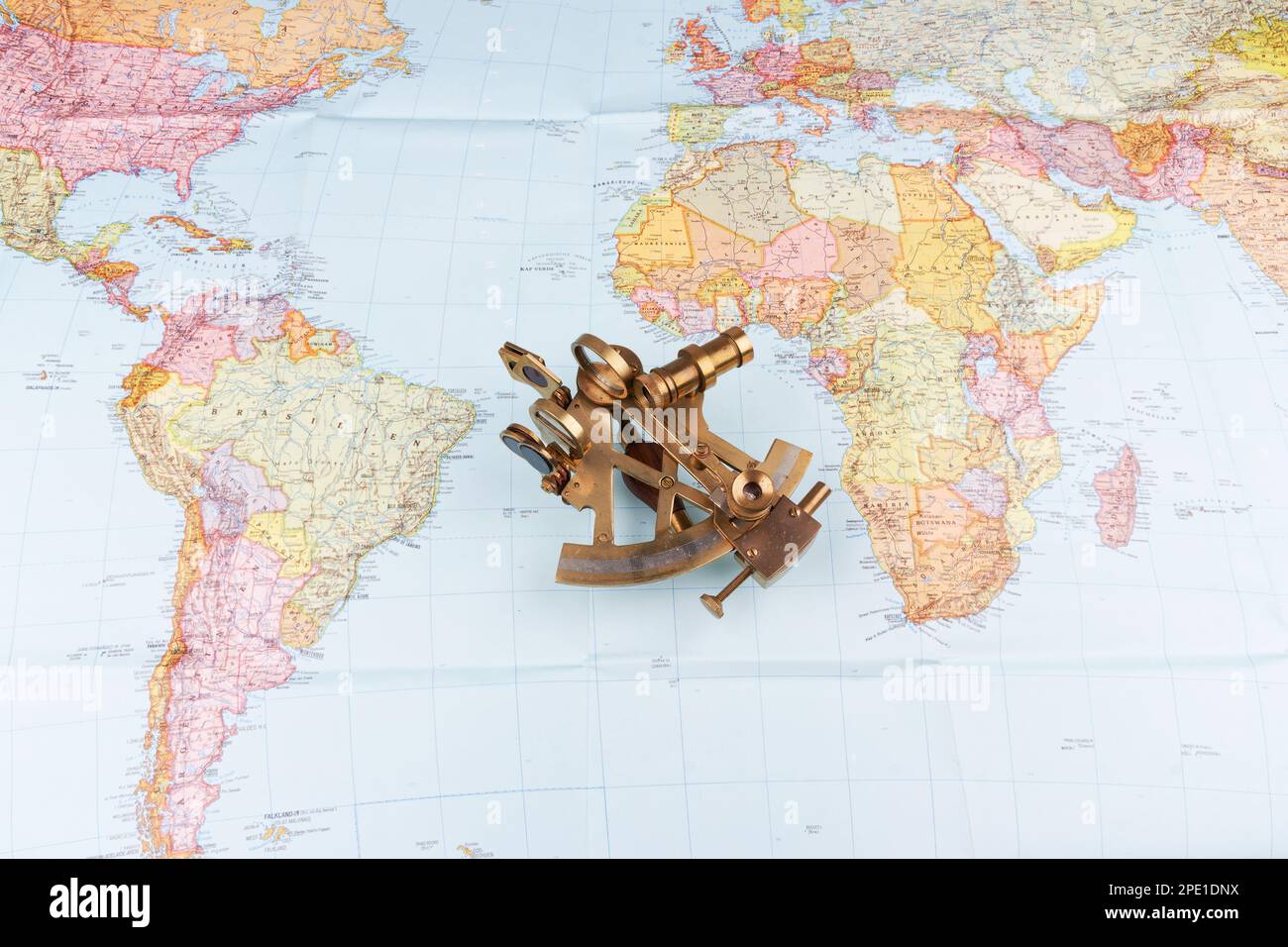 nautical sextant with optics lying on paper world map Stock Photo - Alamy