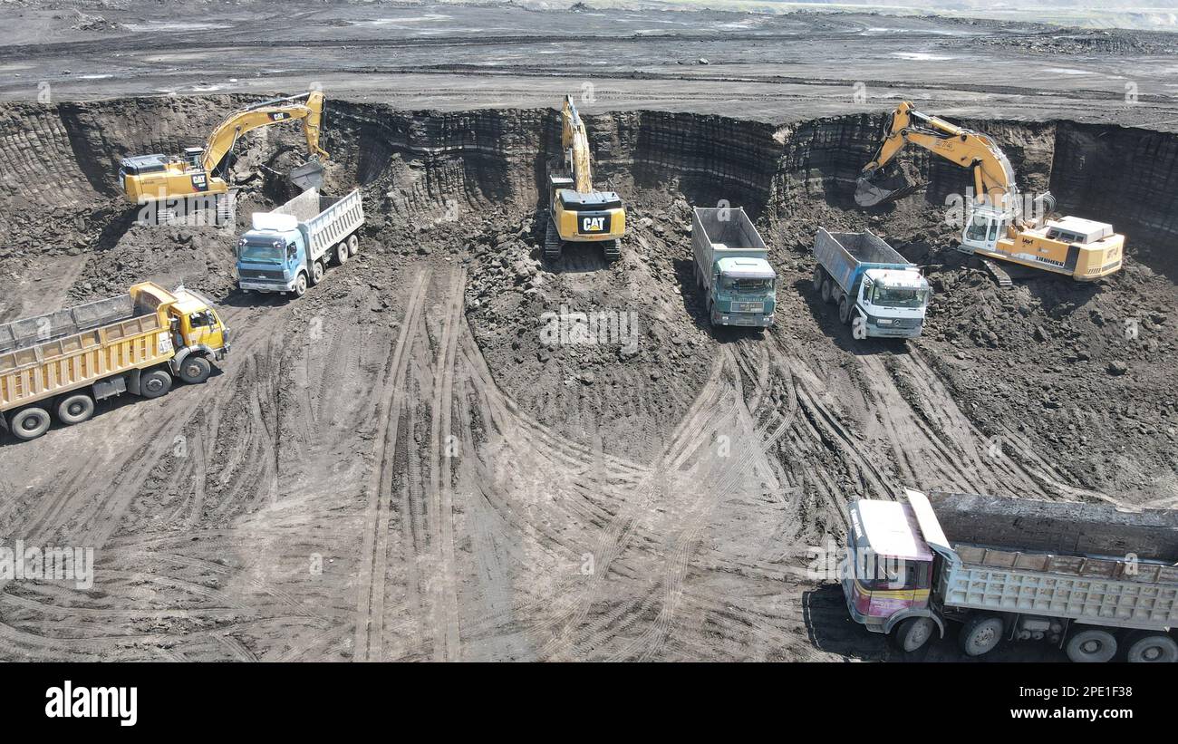 Excavators Working On Huge Mining Site, Loading The Trucks, Trucks ...
