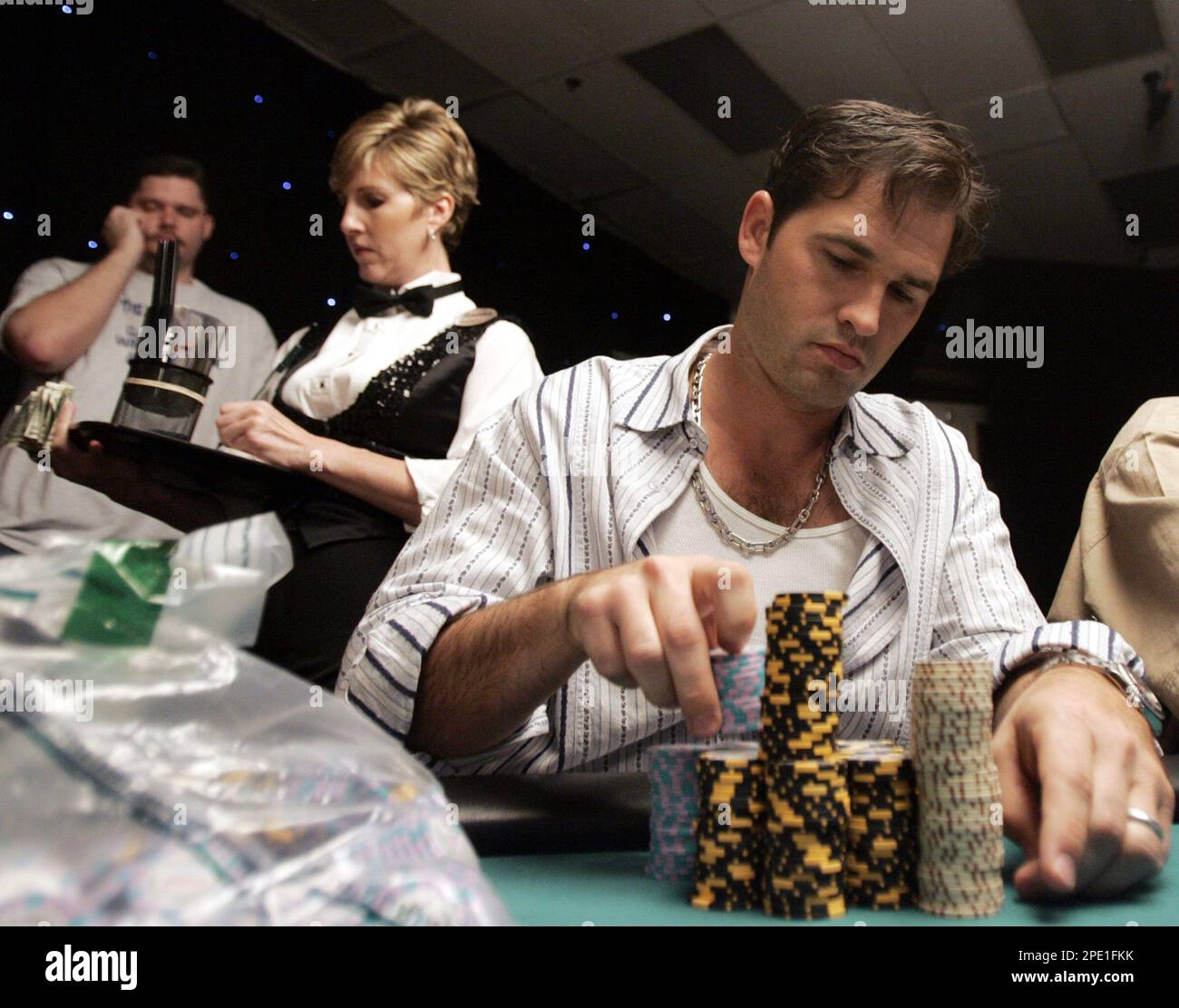 John "Tex" Barch of McKinney, Texas, counts his chips before play ...