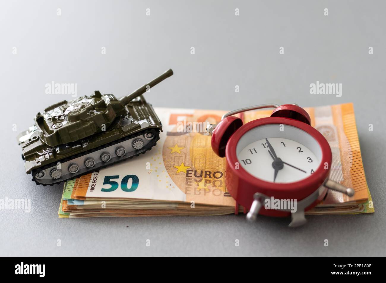 Economic crisis concept. Toy military tank on euro banknotes. War ...