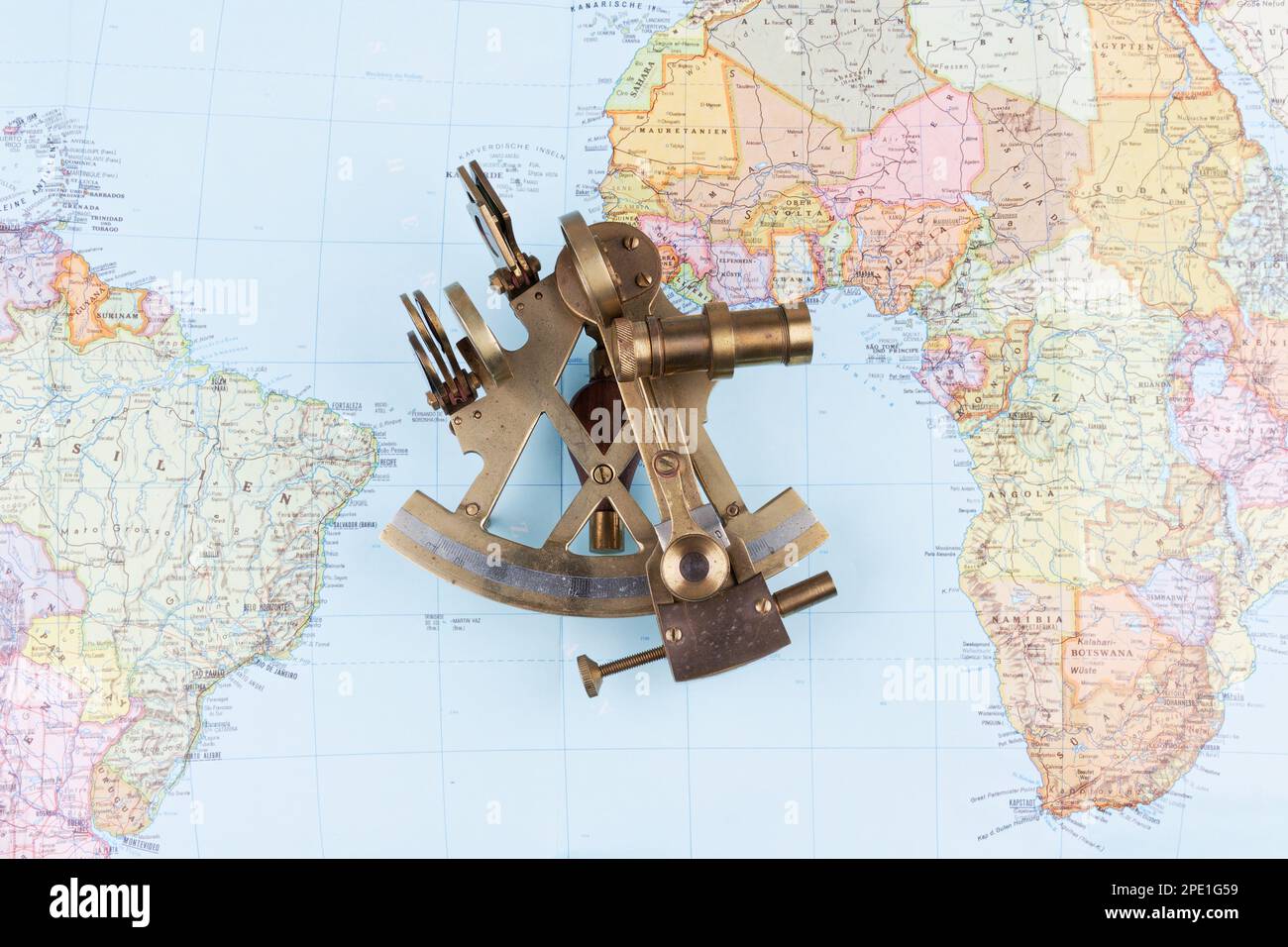 nautical sextant with optics lying on paper world map Stock Photo - Alamy