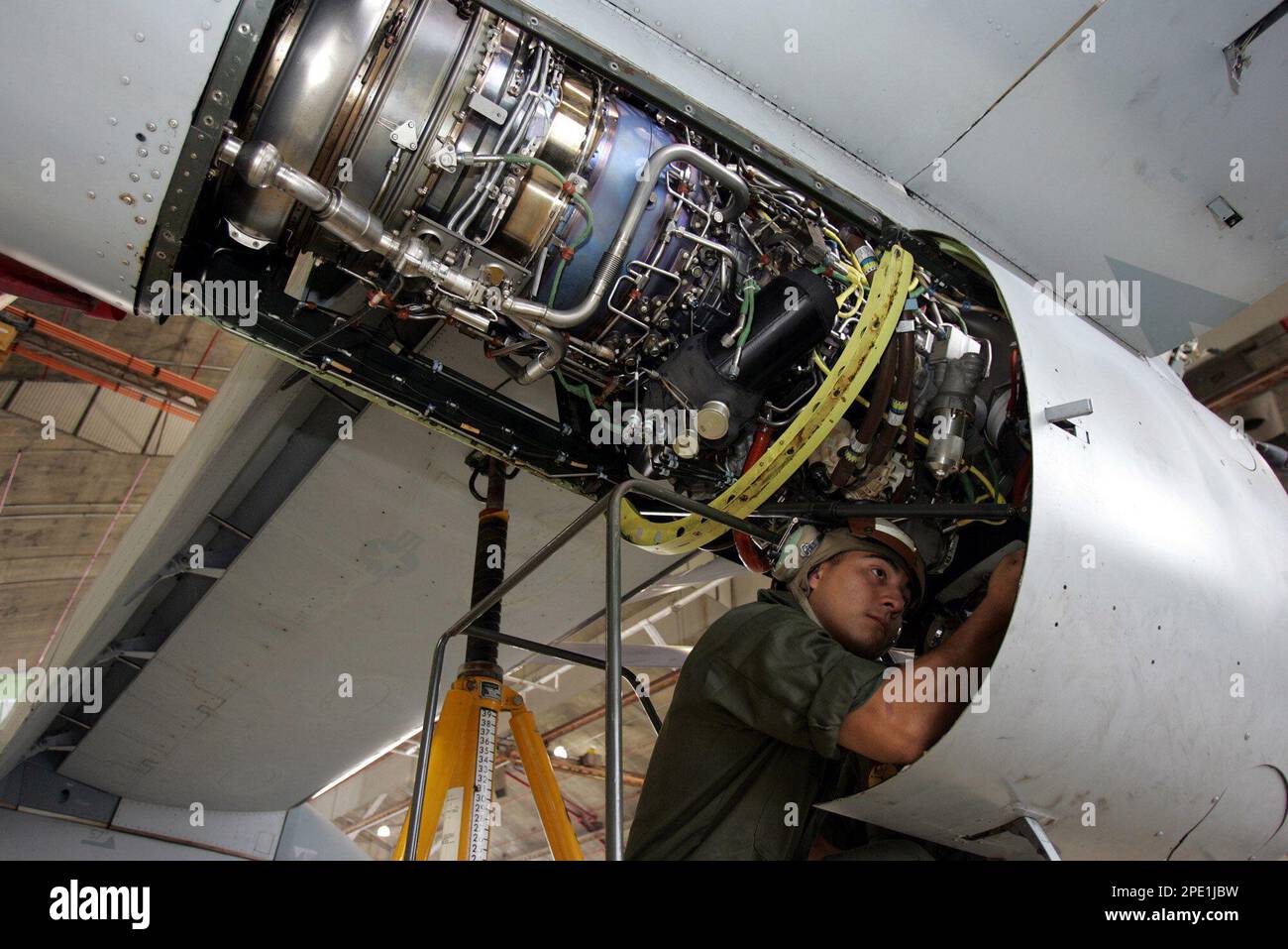 U.S. Marine Corps Cpl. Ivan Aguirre, flight line mechanic, works on one ...