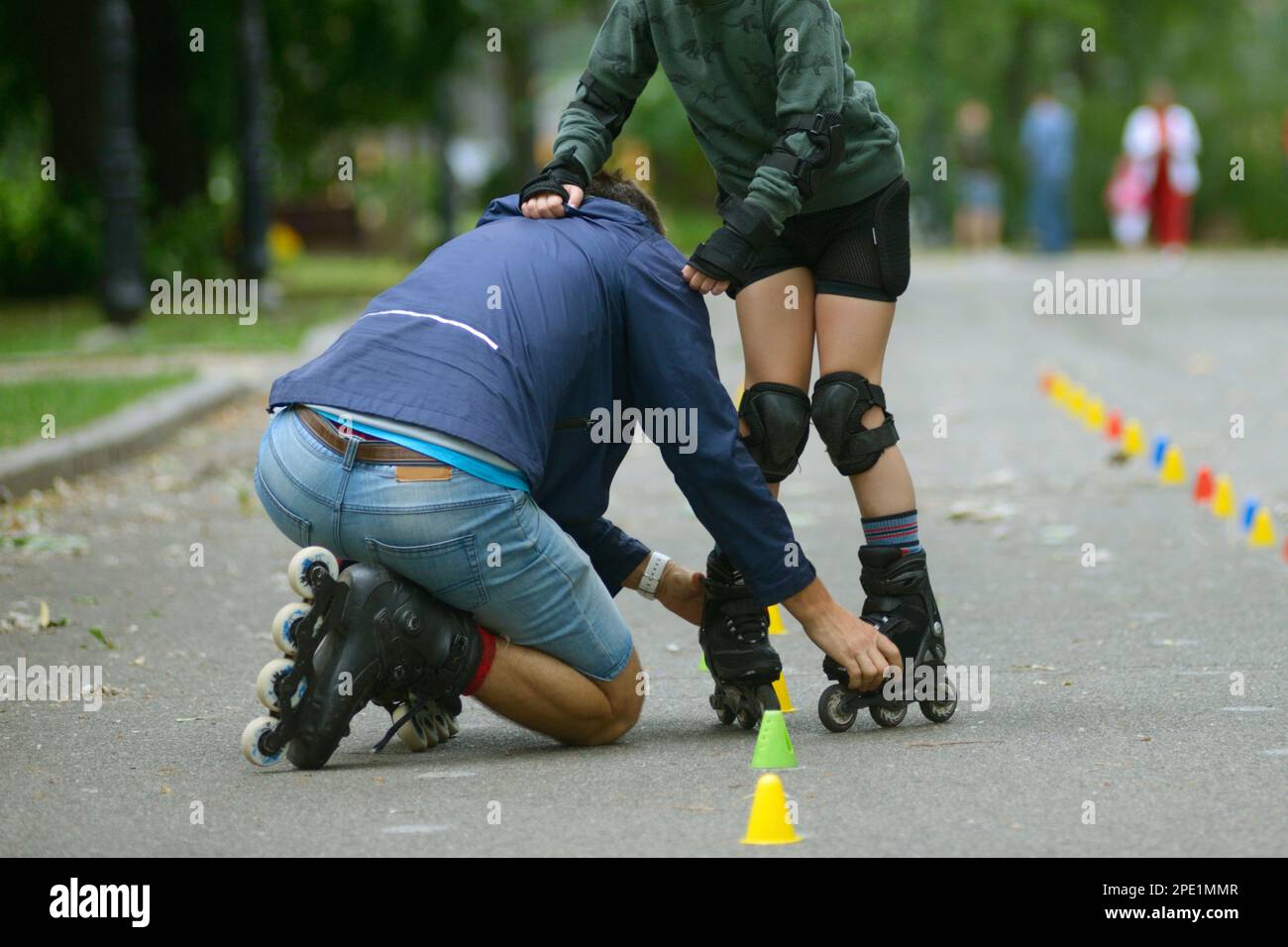 Rollerblading. Trainer corrects boy movements teaching of artistic ...